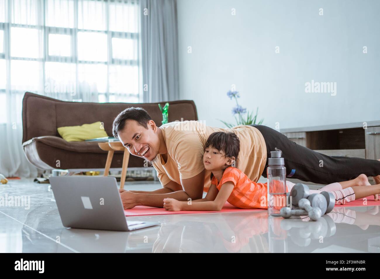 asian Fit Young Man Exercise Mat While Lifting One Leg and Looking to ...