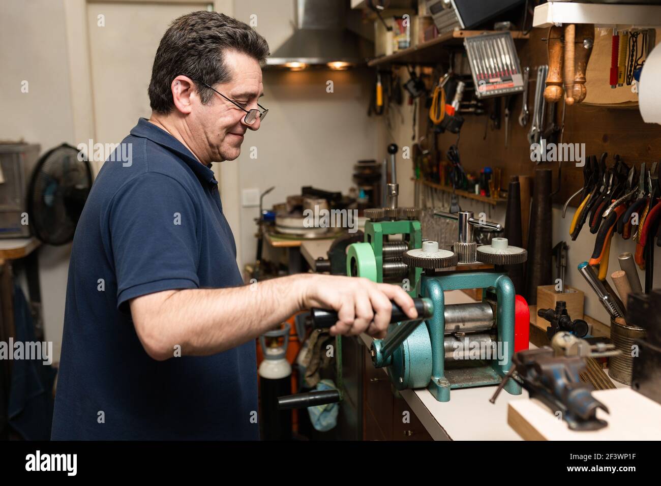 a man stretches a piece of silver to make a ring Stock Photo - Alamy
