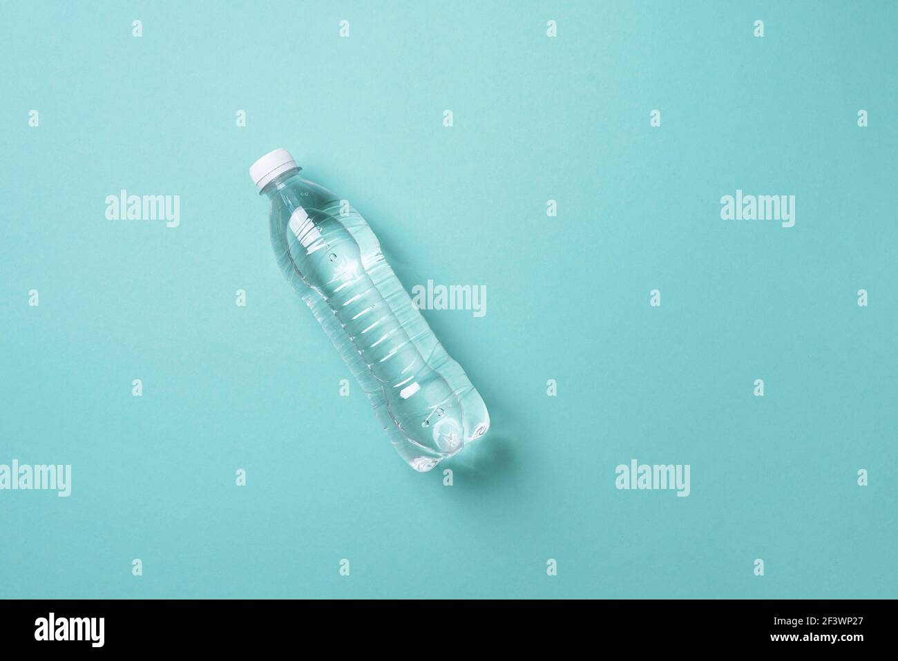 Water balance. Pure water in bottle for healthy lifestyle on blue ...