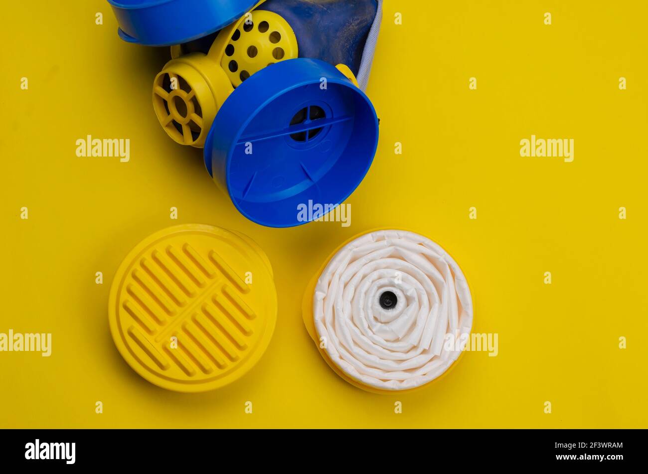 Industrial respirator with replaceable filters on a yellow background ...