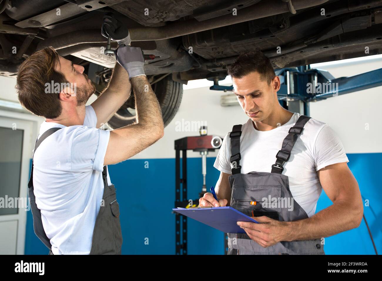 Mechanic fixing the car with wrench, service engine vehicle Stock Photo ...