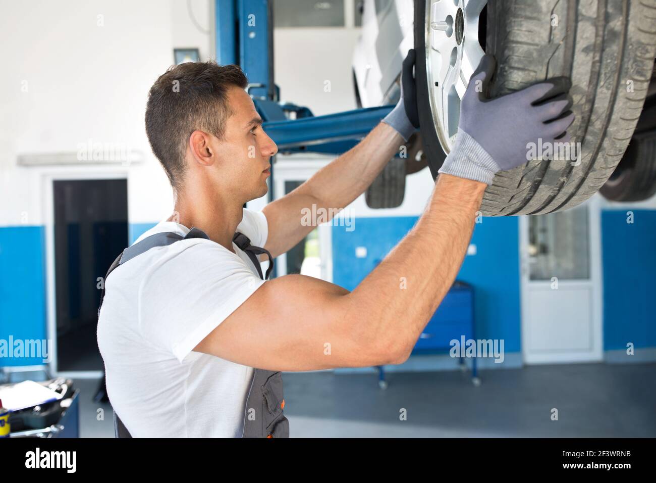 Control, cheking and changing a wheel on a car at workshop Stock Photo ...
