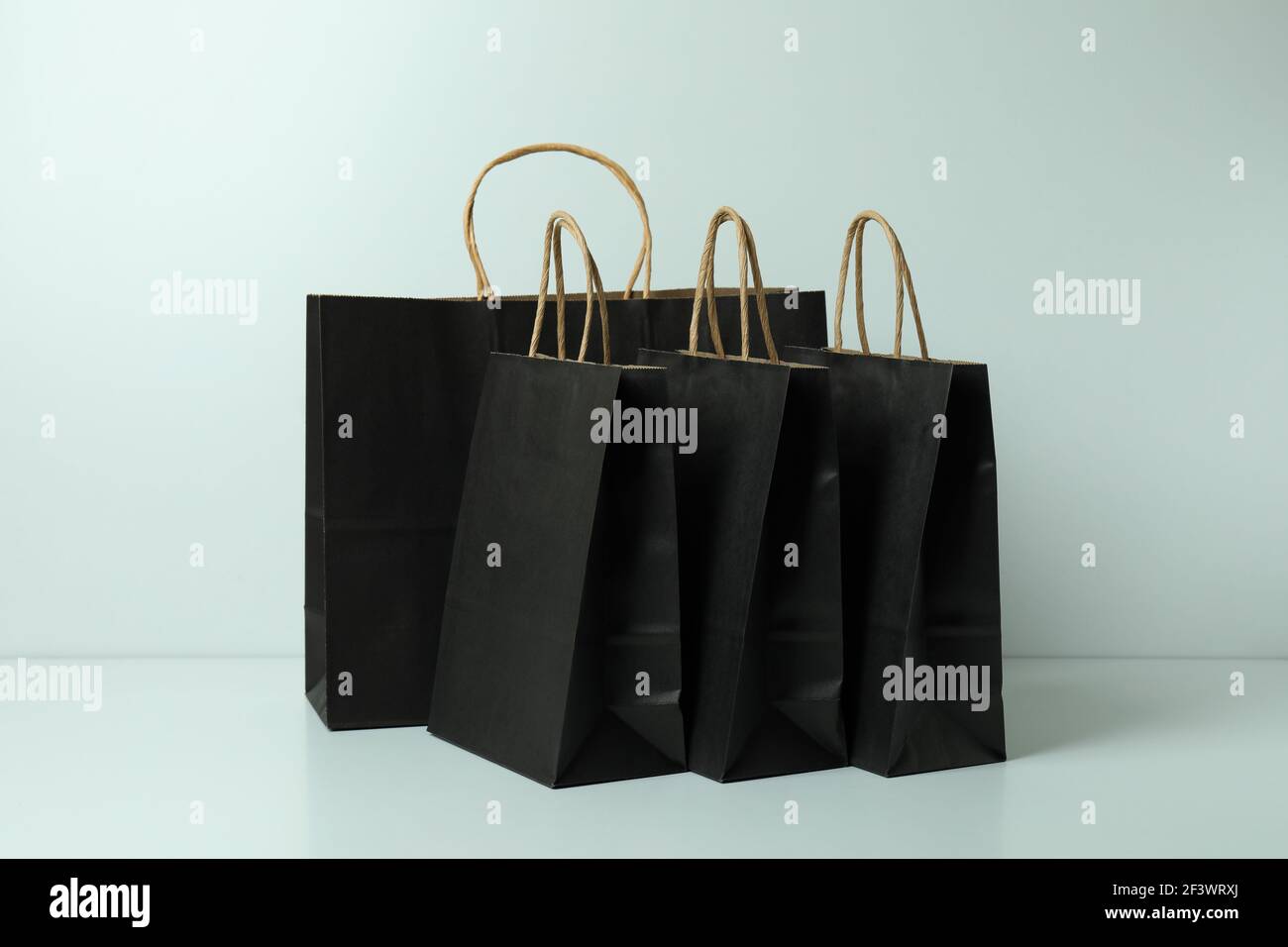 Group of black paper bags on white background Stock Photo - Alamy