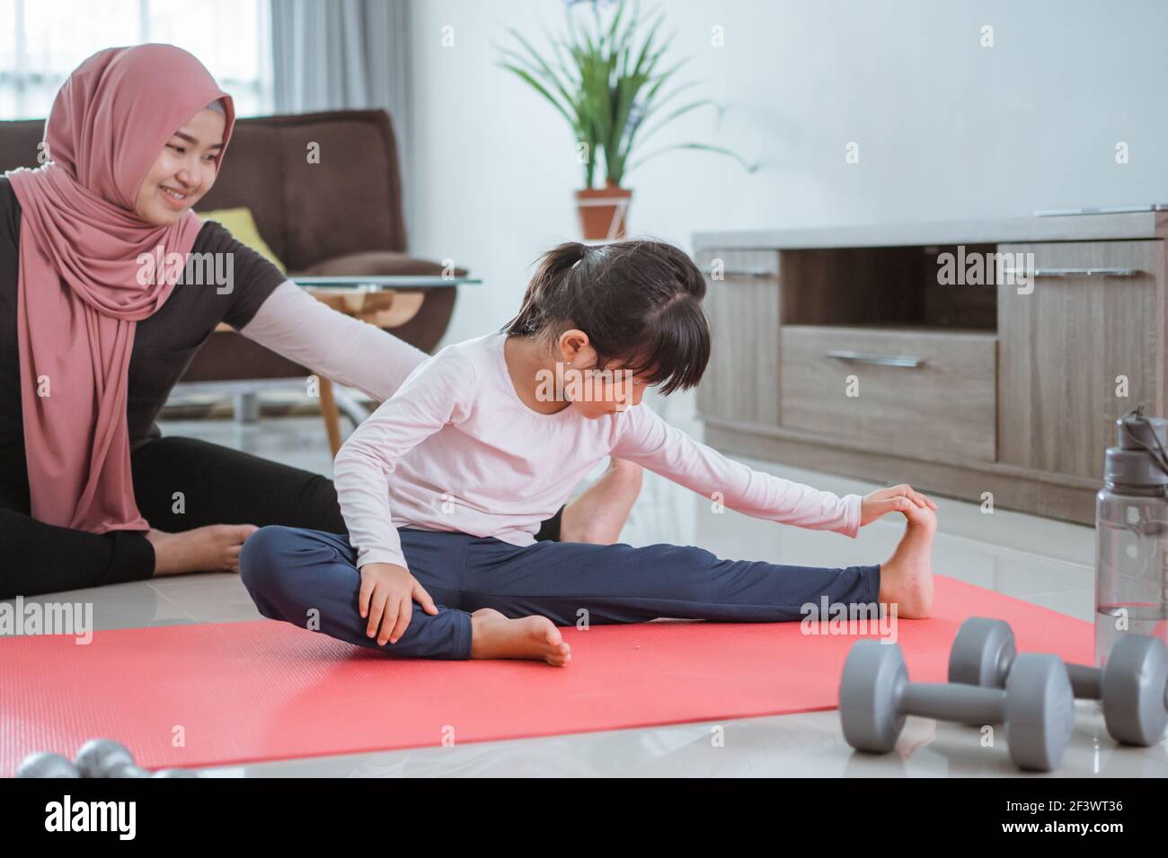 muslim woman doing sport and exercise with daughter at home Stock Photo ...