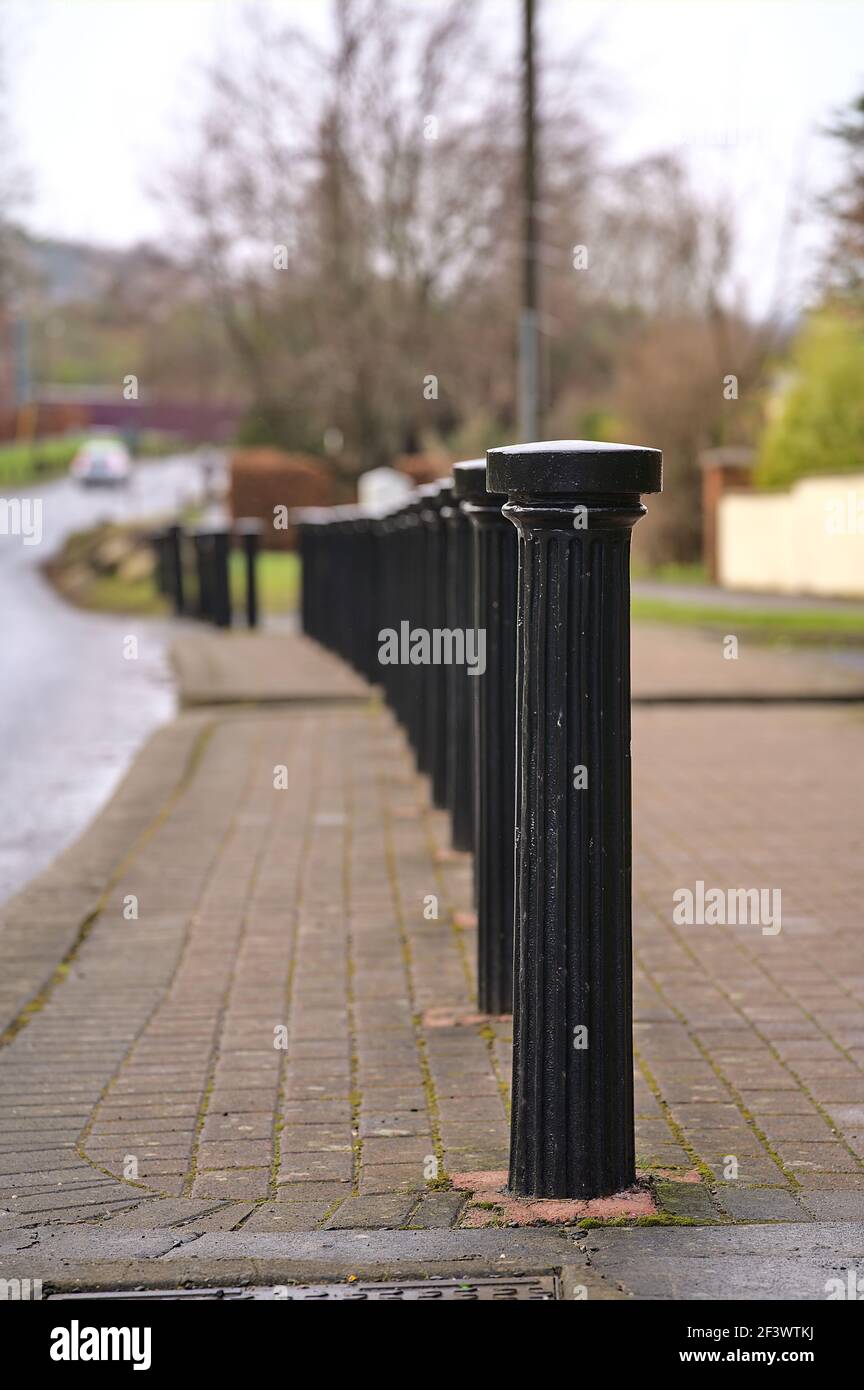 Beautiful vertical view of inline black metal road blockers to prevent ...