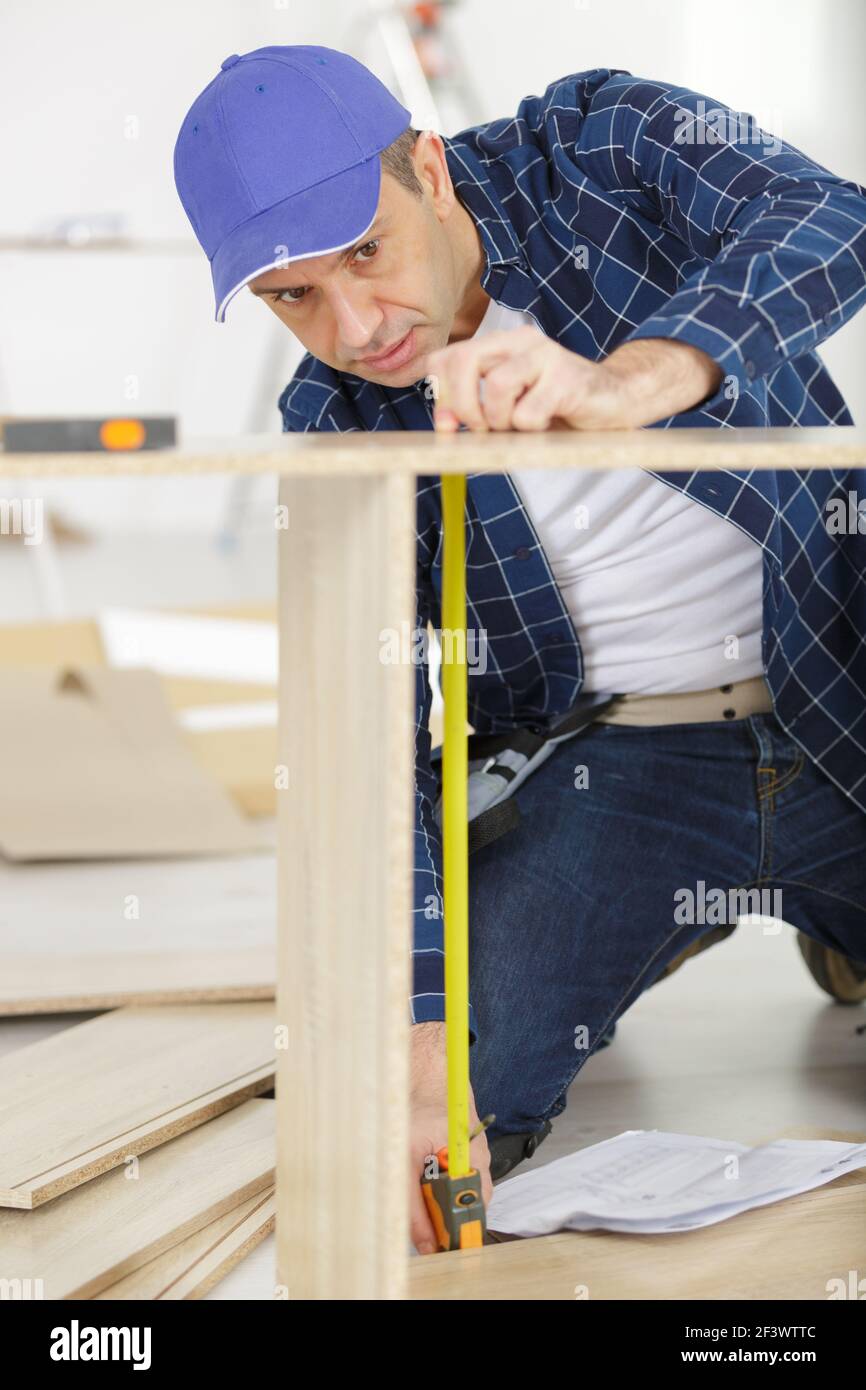 Man using tape to measure cabinet hi-res stock photography and images ...
