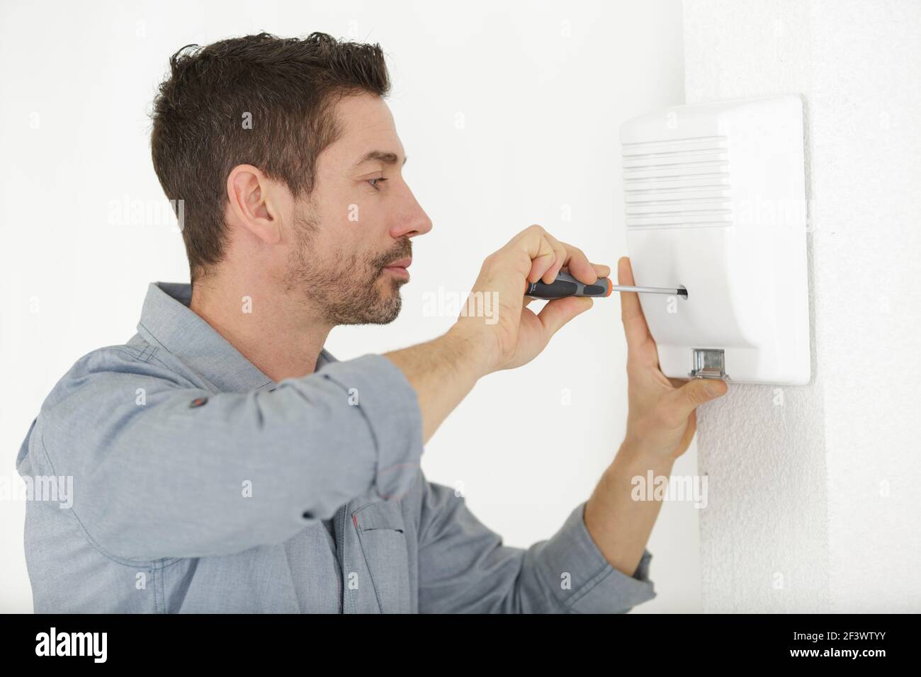 electrician fixing electric panel in private home Stock Photo - Alamy