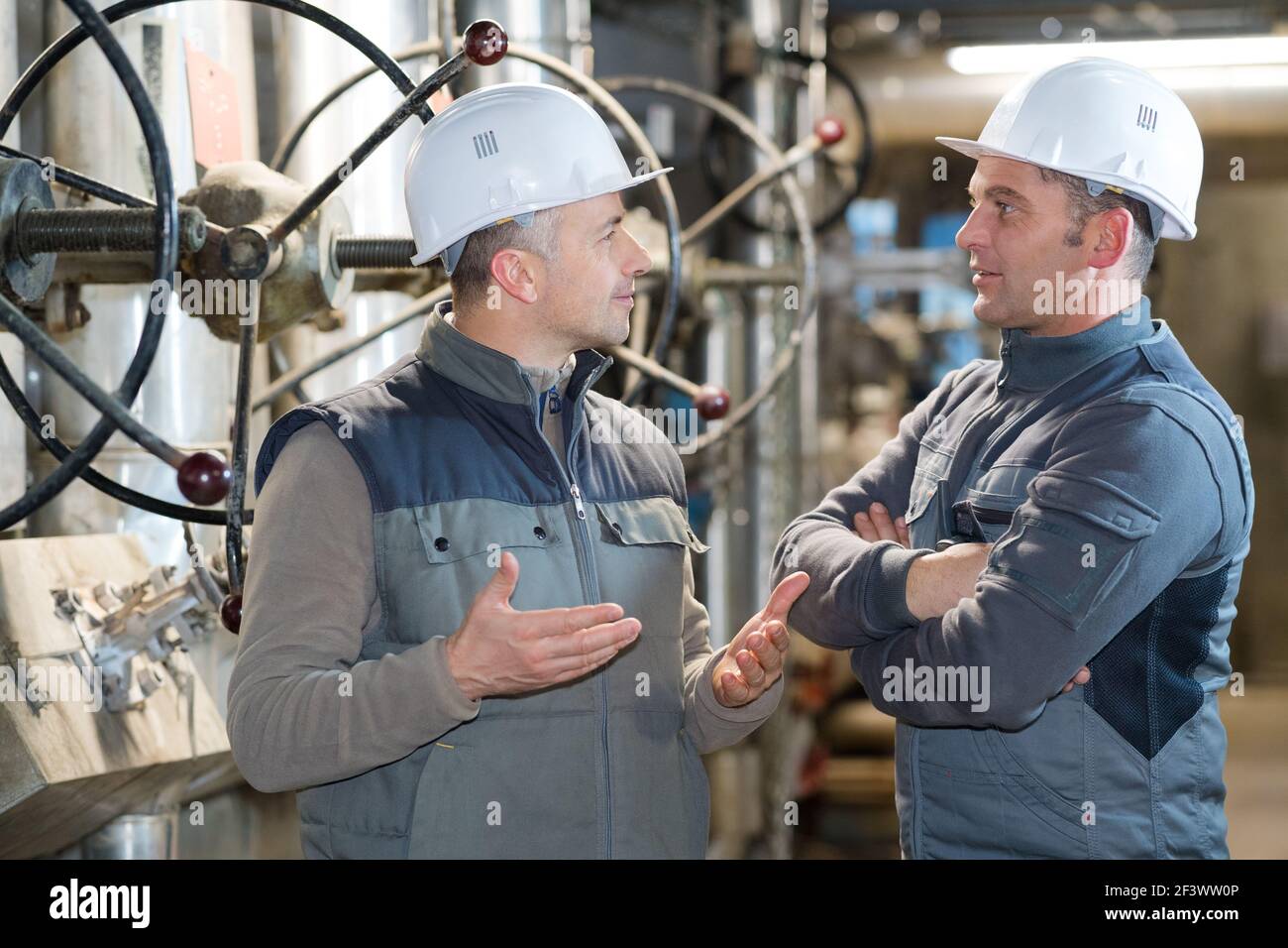 confident male workers taking in industry Stock Photo - Alamy