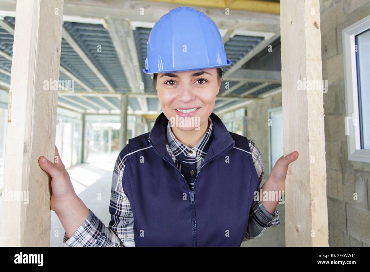 happy female builder indoors at building site Stock Photo - Alamy