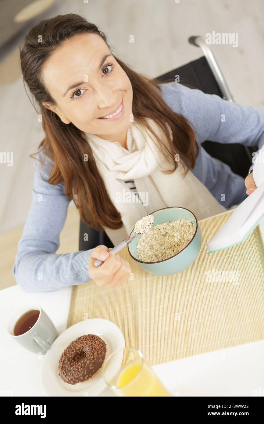 happy disabled woman eating breakfast Stock Photo - Alamy