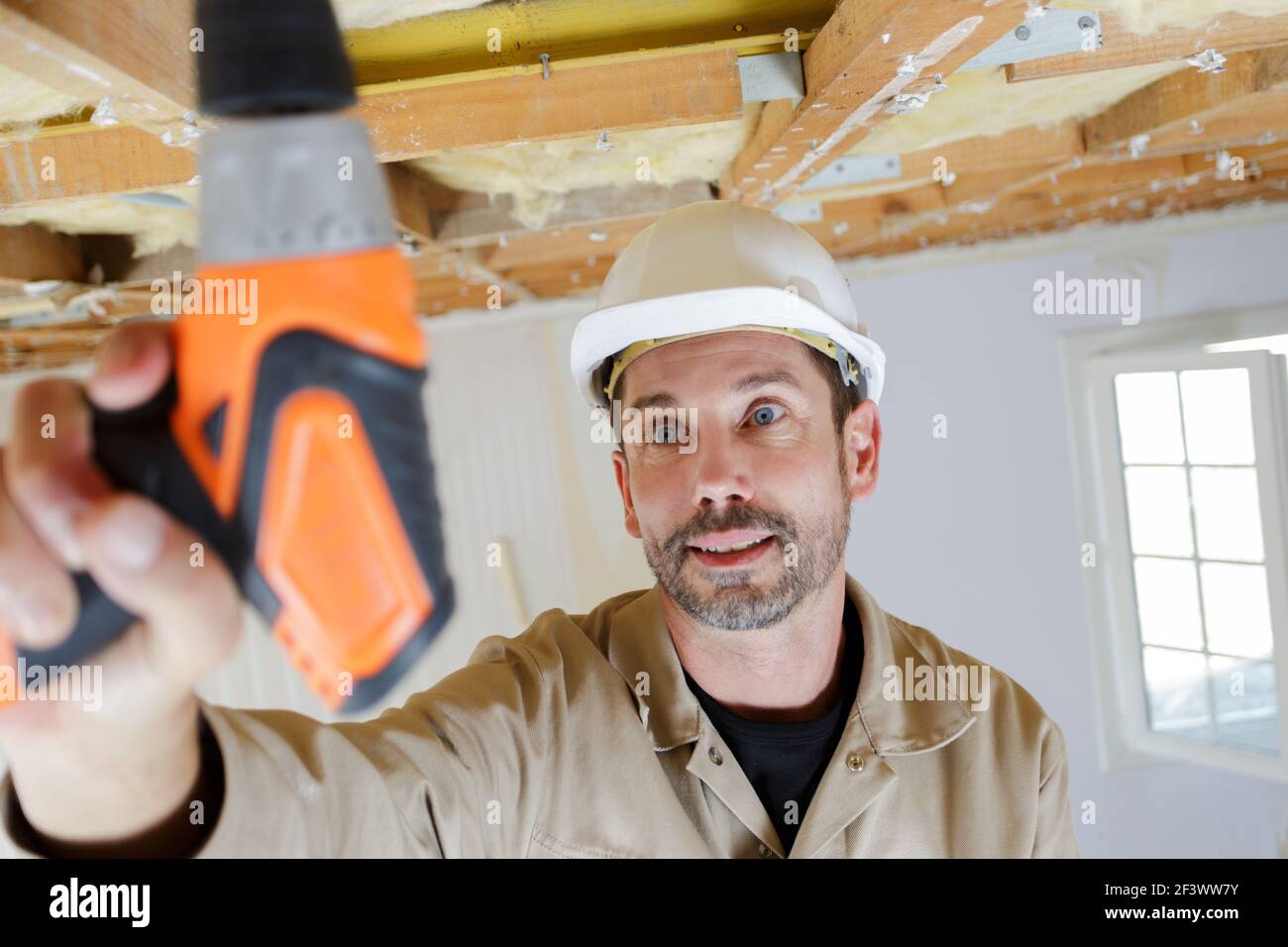 manual worker drilling ceiling with a drilling machine Stock Photo - Alamy