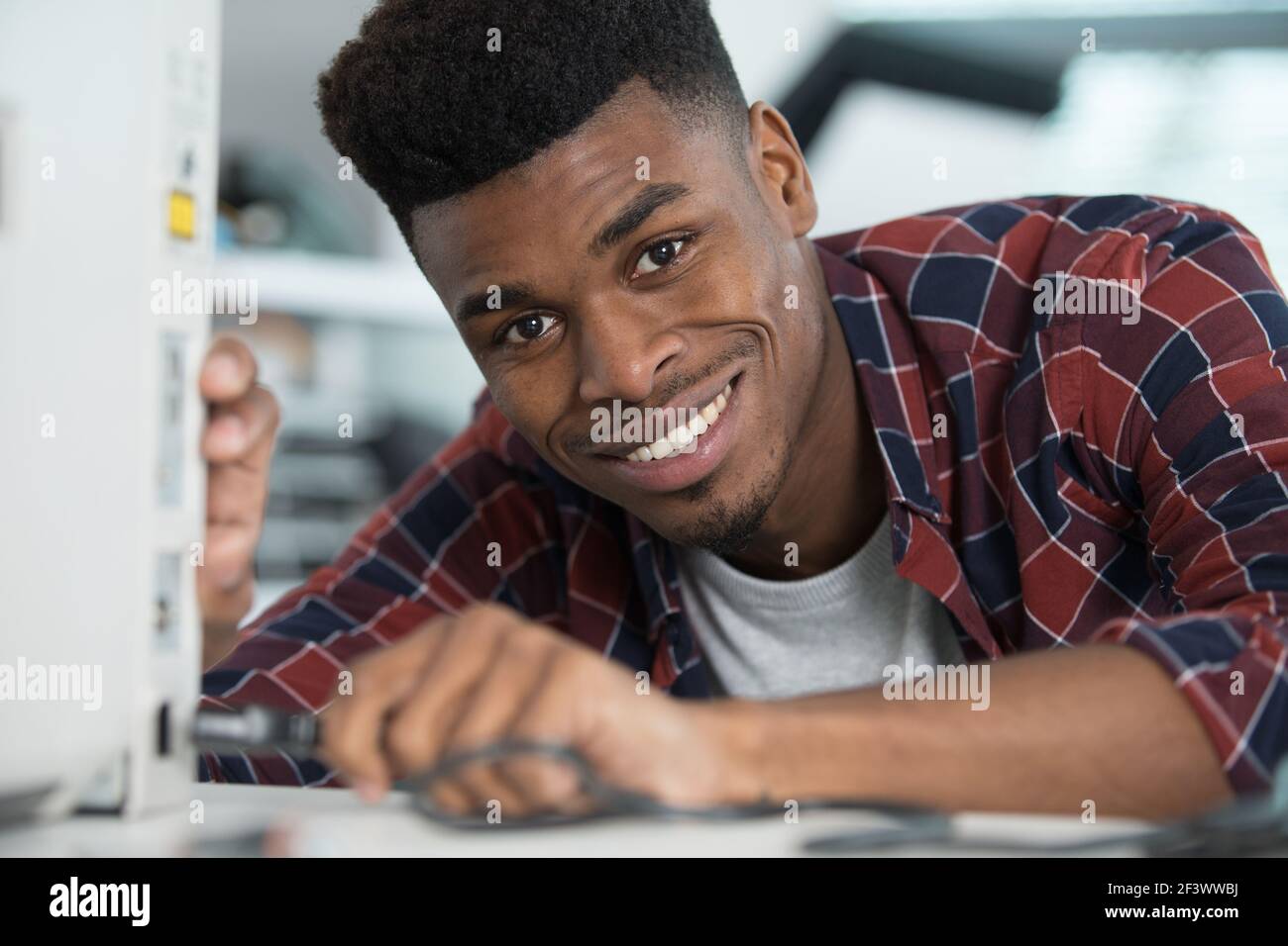 Man plugging computer hi-res stock photography and images - Alamy