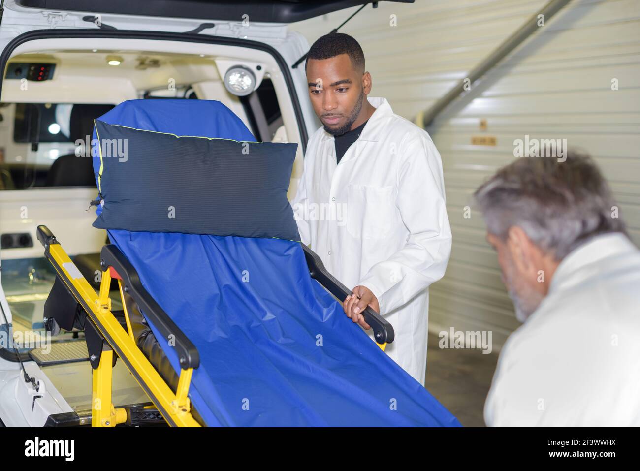 paramedic team preparing the folding bed Stock Photo - Alamy