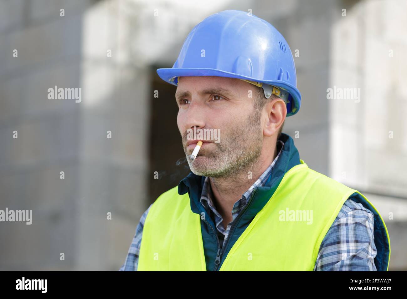 smoking cigarette on construction site Stock Photo - Alamy