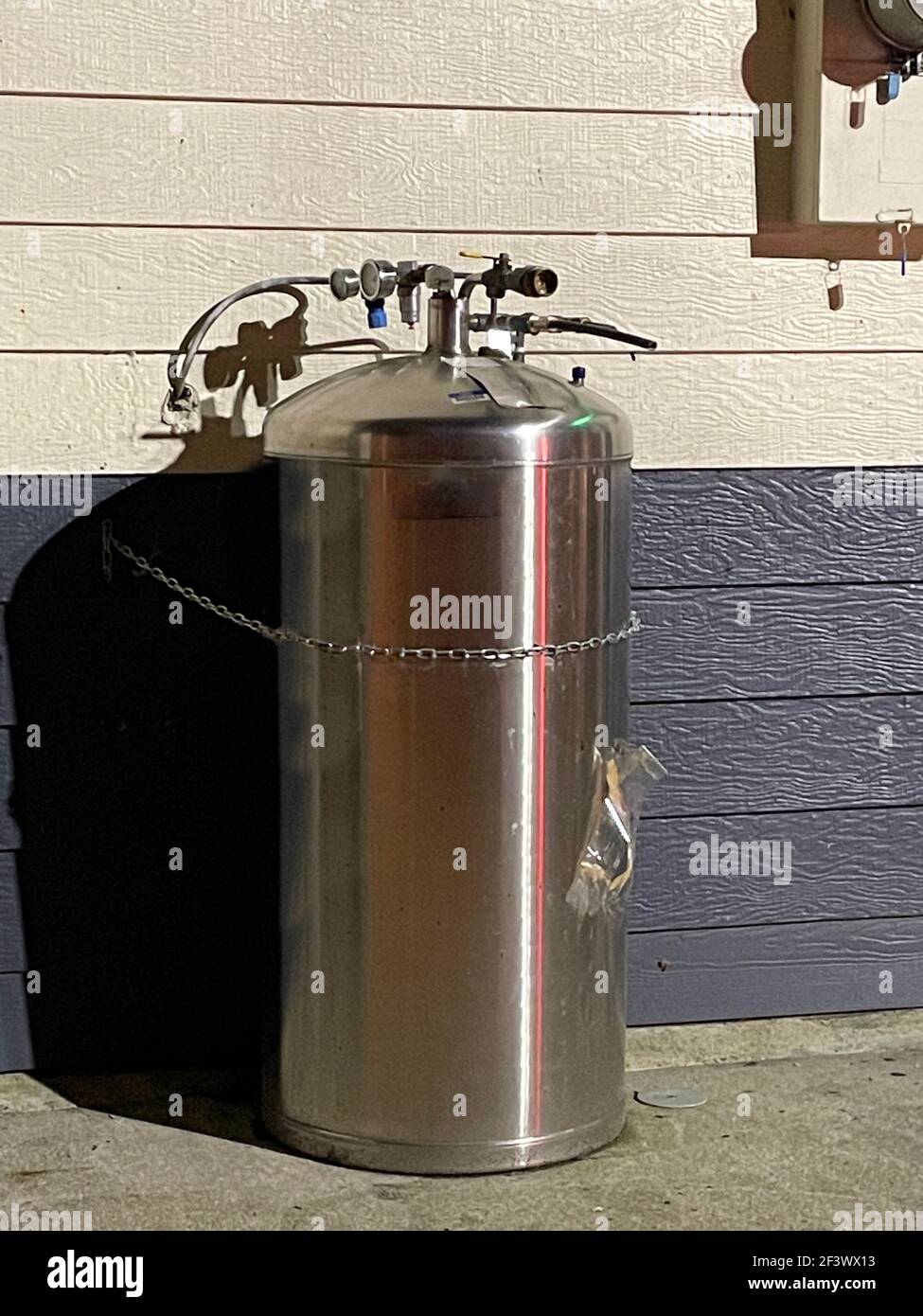 Augusta, Ga USA - 02 21 21: A metal carbonated drink tank chained to a ...