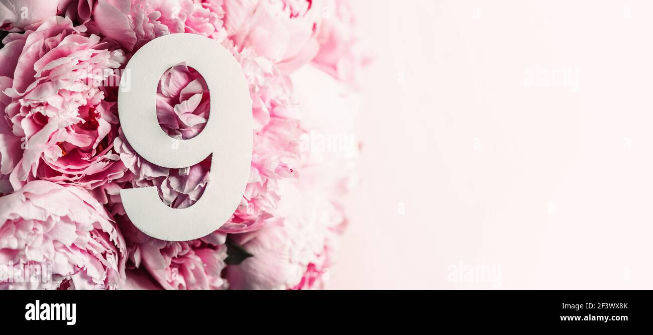Creative layout. Pink peony flowers and digit nine 9. Birthday greeting ...