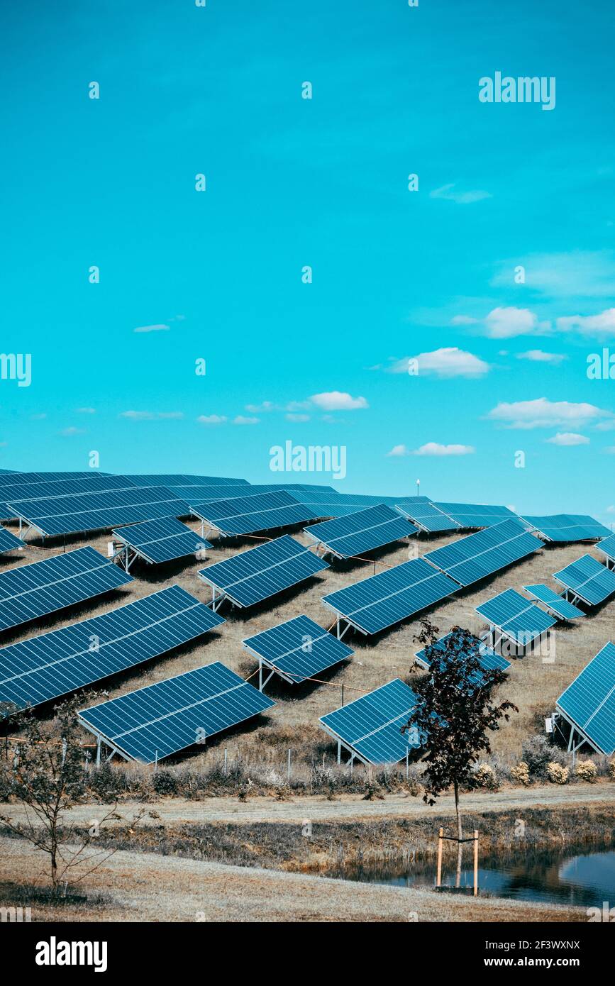 Solar panels against blue sunny sky produce green, environmentally ...