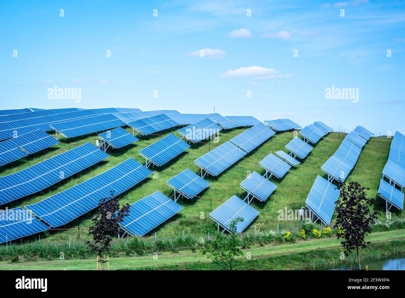 Solar panels against blue sunny sky produce green, environmentally ...