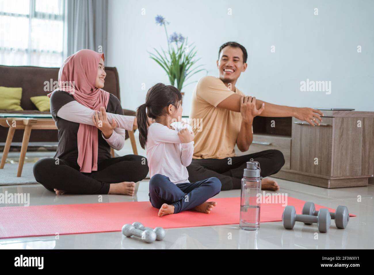 beautiful family exercising at home together Stock Photo - Alamy