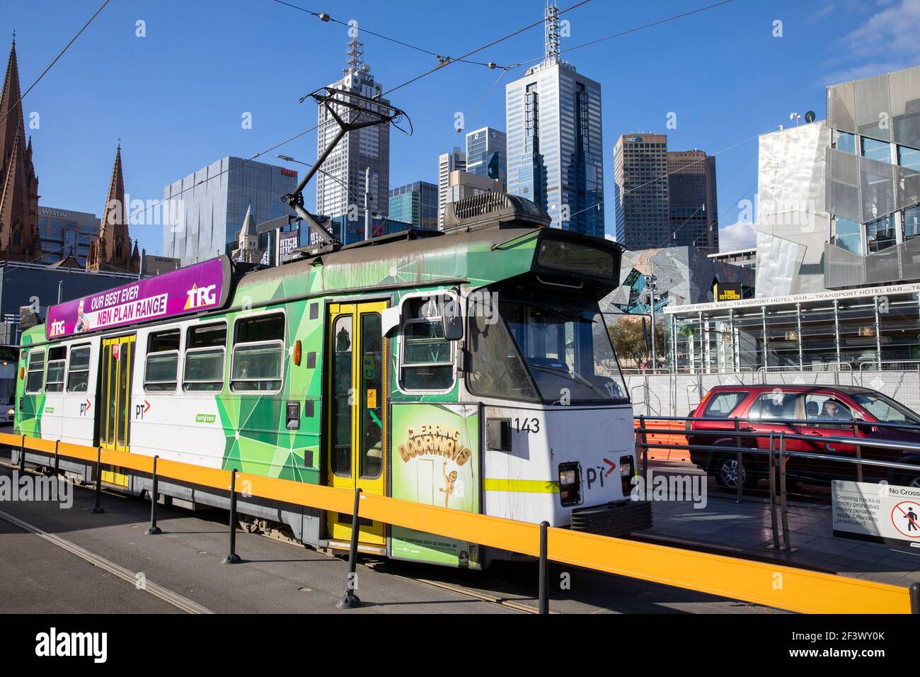 Melbourne tram in the city centre on Princes bridge next to Federation ...