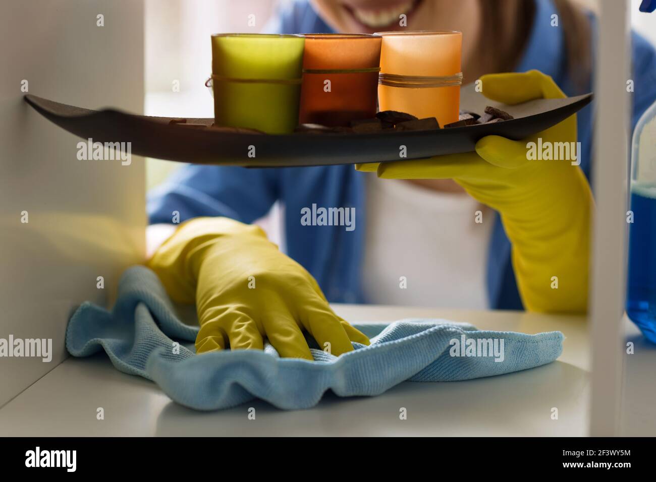Girl with a cloth cleaning shelf close up Stock Photo - Alamy