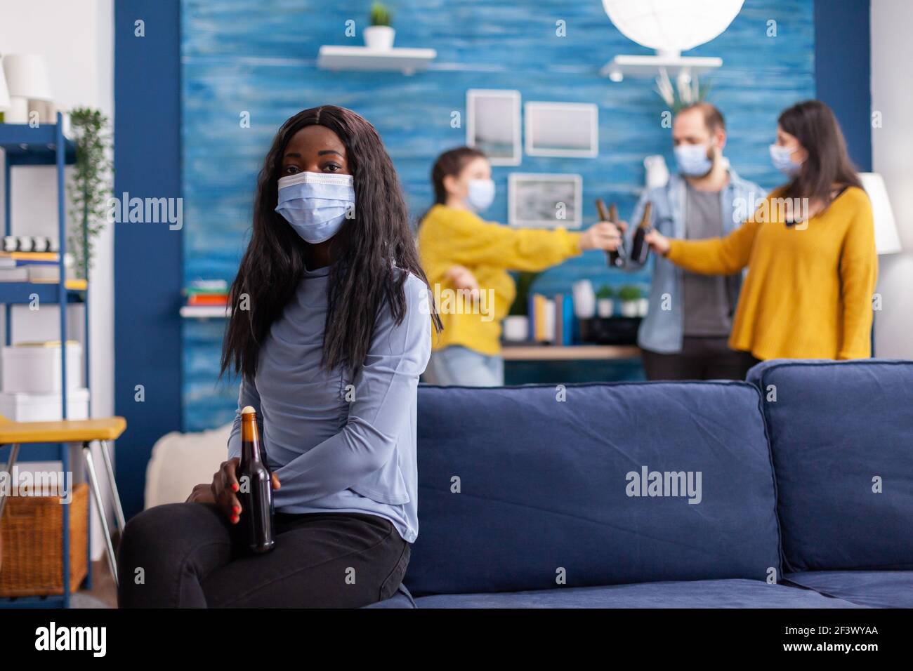 Cheerful african woman enjoying time with friends keeping social ...