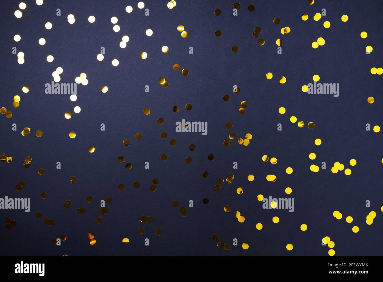 Golden confetti on red background with light bokehs. Happy new year ...