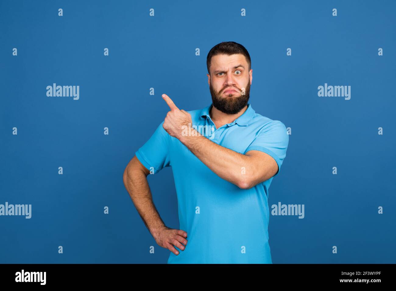 Caucasian man's portrait isolated on blue studio background with ...