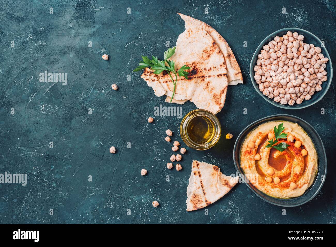 Hummus, chickpea dip, olive oil, raw beans, smoked paprika, pita on ...