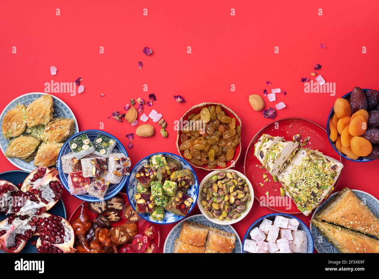 Middle Eastern sweets on red background. Arab dessert, baklava, halva ...