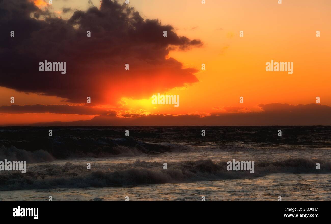 Sunset over the ocean. Stormy weather Stock Photo - Alamy