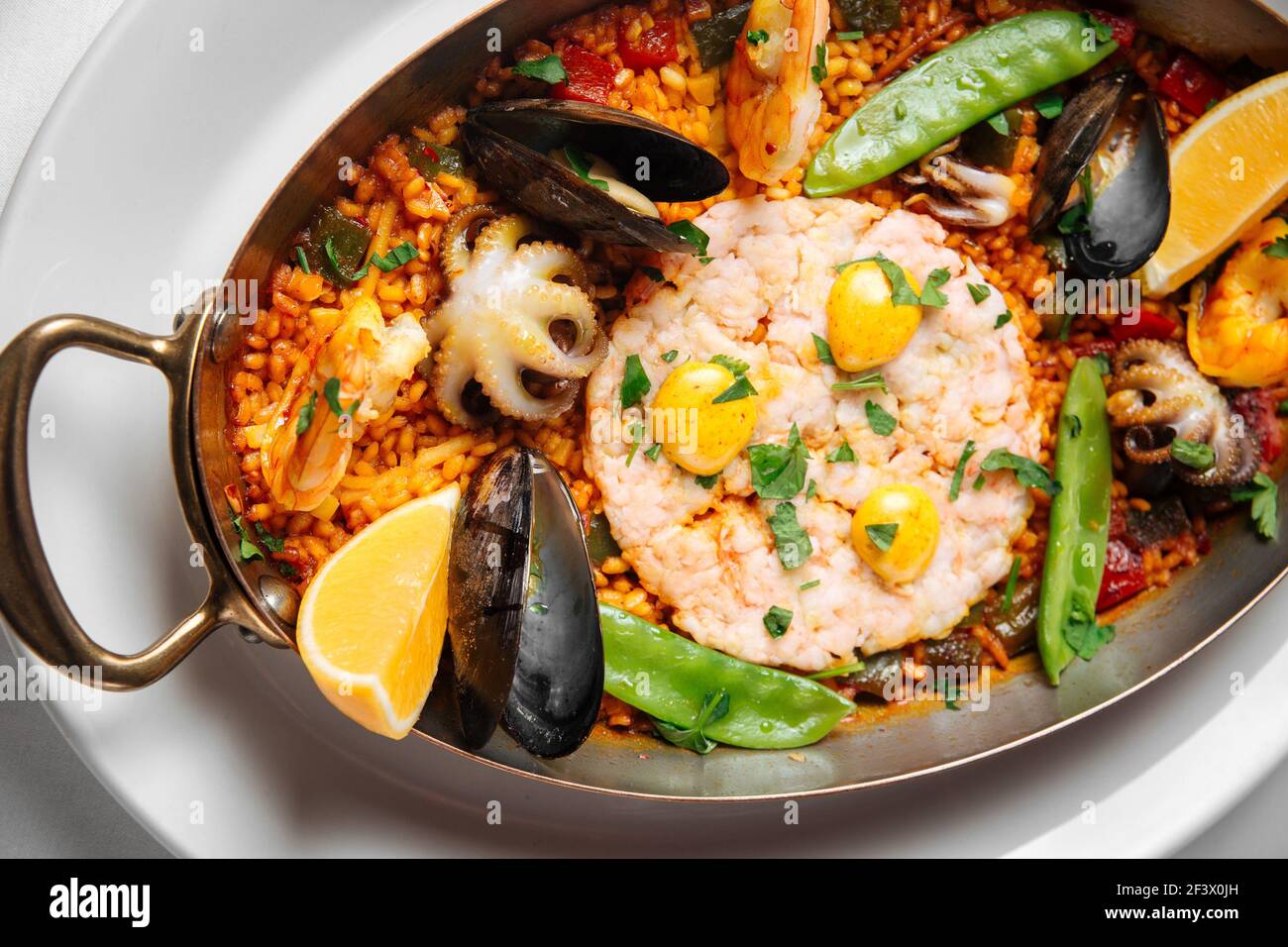 Spanish paella with seafood and rice in a pan Stock Photo - Alamy