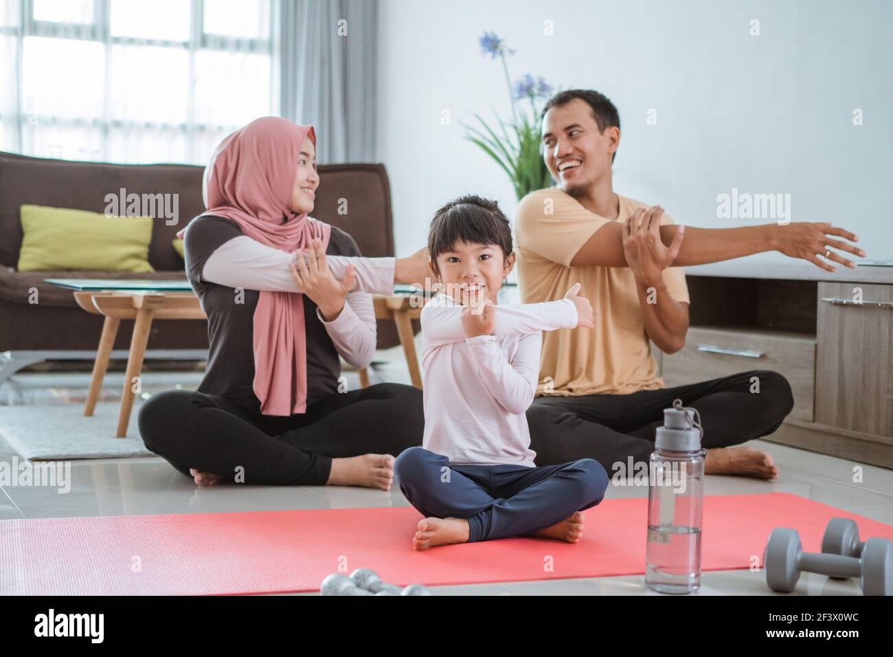 beautiful family exercising at home together Stock Photo - Alamy