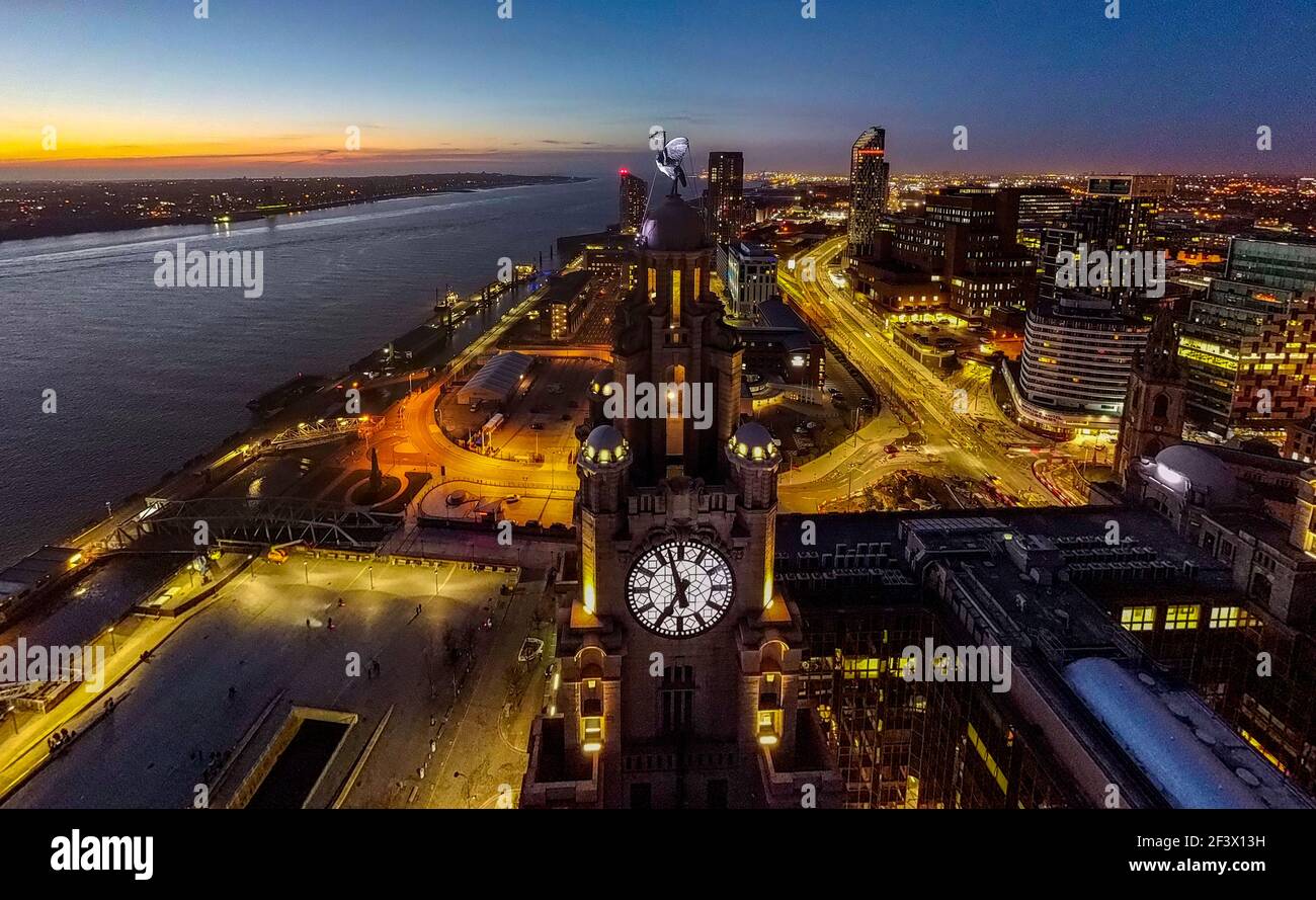 The sun sets behind the Royal Liver Building in Liverpool. Picture date ...