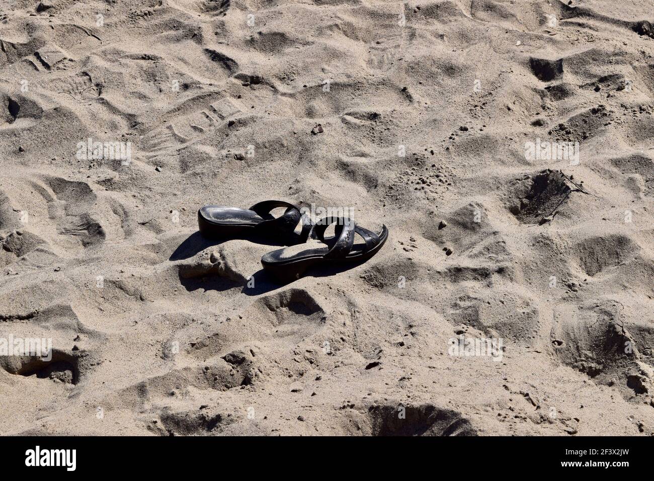 A pair of women's sandals on the beach sand Stock Photo - Alamy
