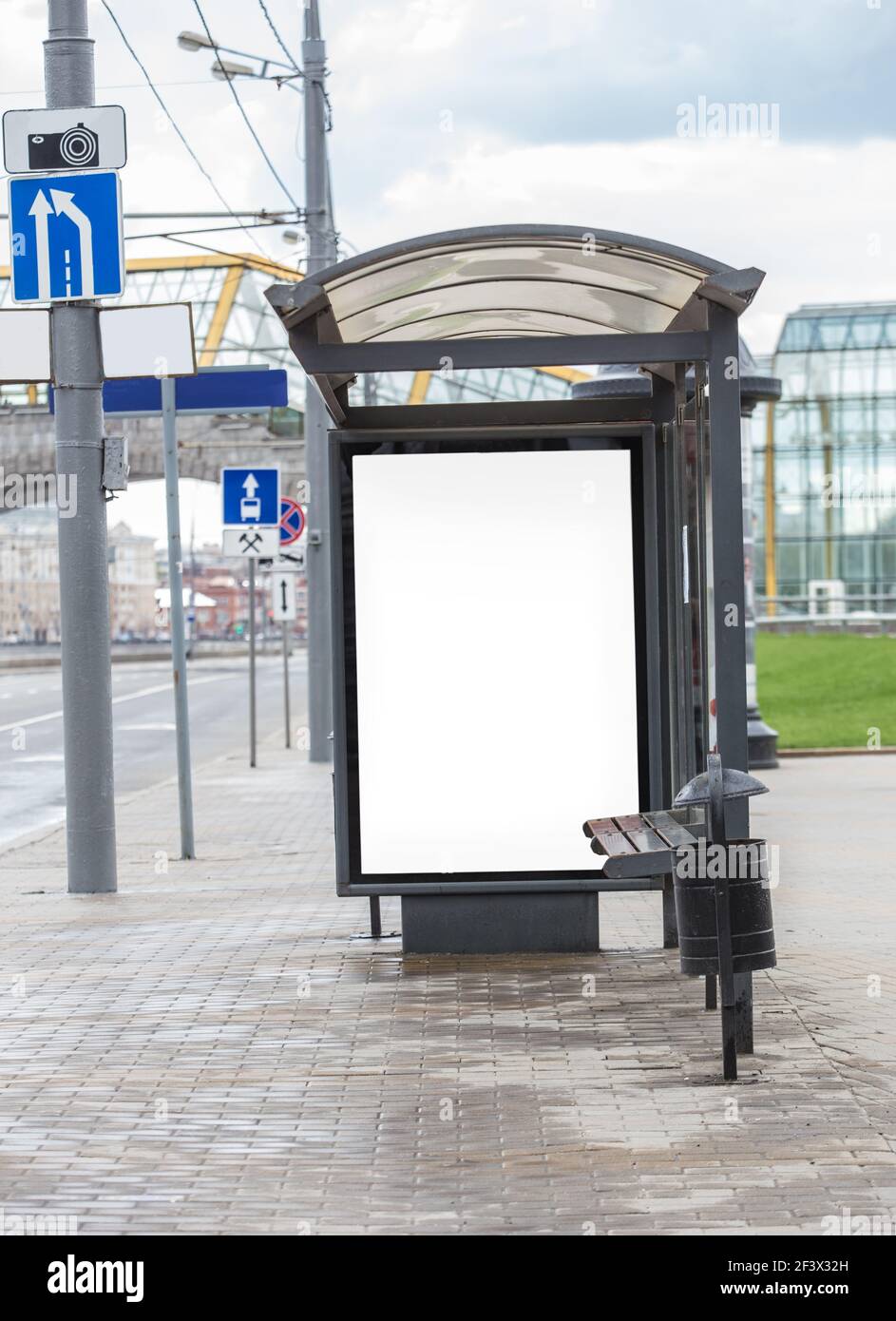 modern glass bus stop with advertising banner Stock Photo - Alamy