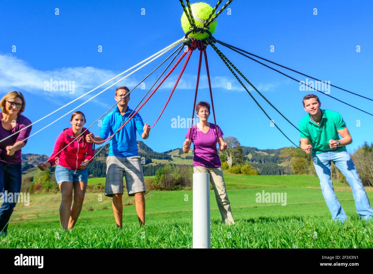Teambuilding exercise called ball transport Stock Photo - Alamy
