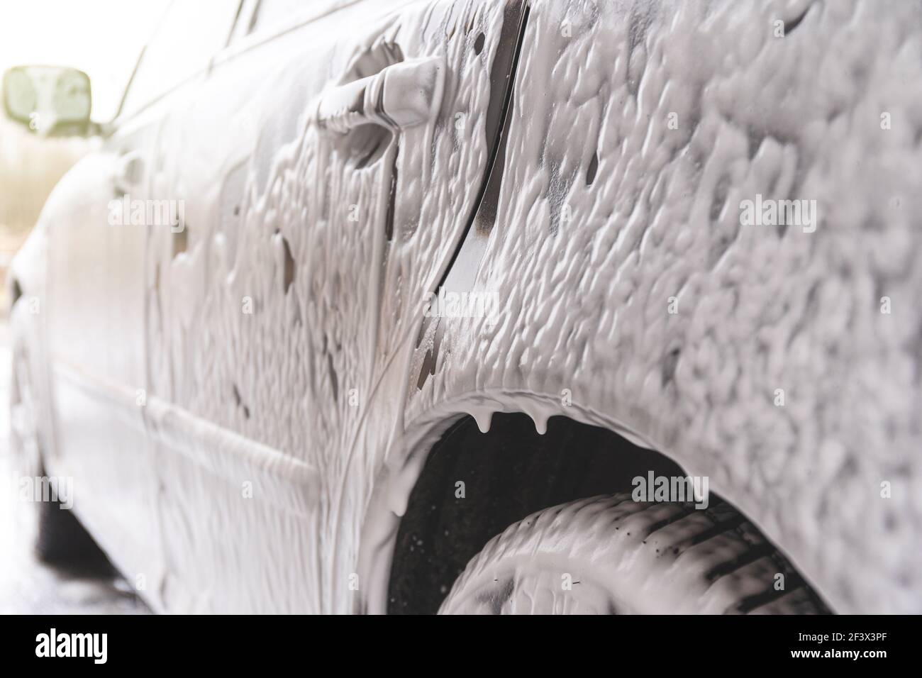 Car covered with washing foam at contactless car washing service Stock ...