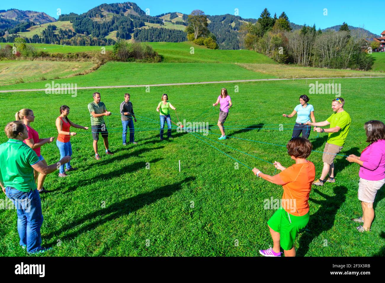 Teambuilding exercise called ball transport Stock Photo - Alamy