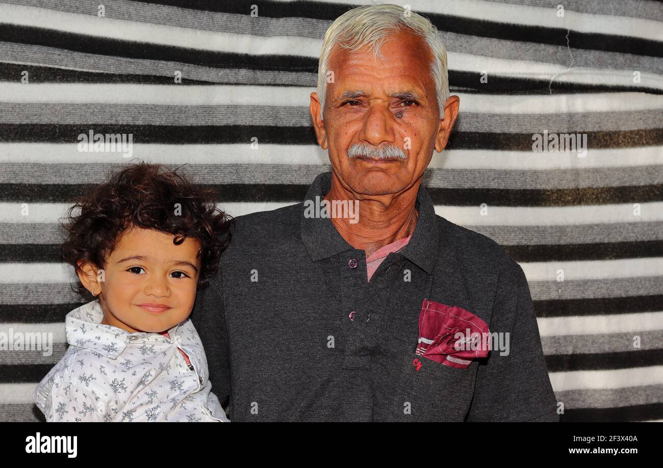 Portrait photo of an indian senior happy grandfather and younger happy ...
