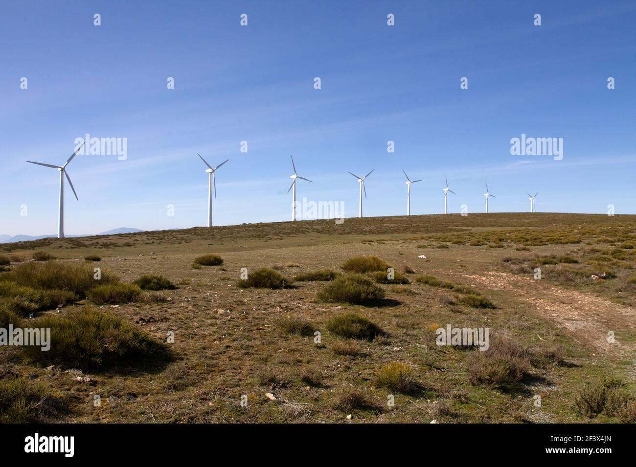 wind turbines producing electricity on a mountain divide in a strong ...
