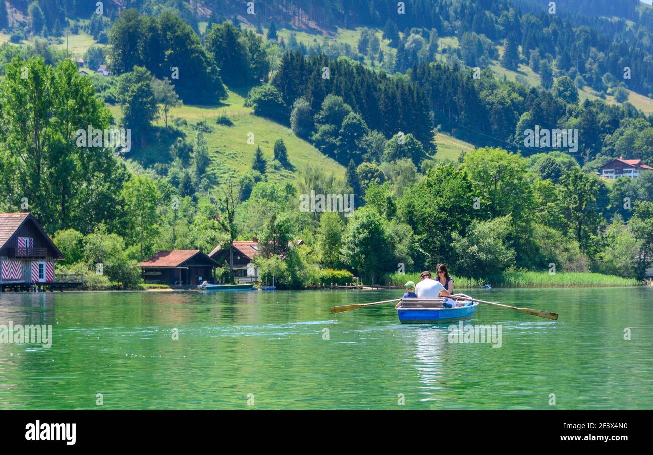 Family tour with rowboat on Alpsee Stock Photo - Alamy