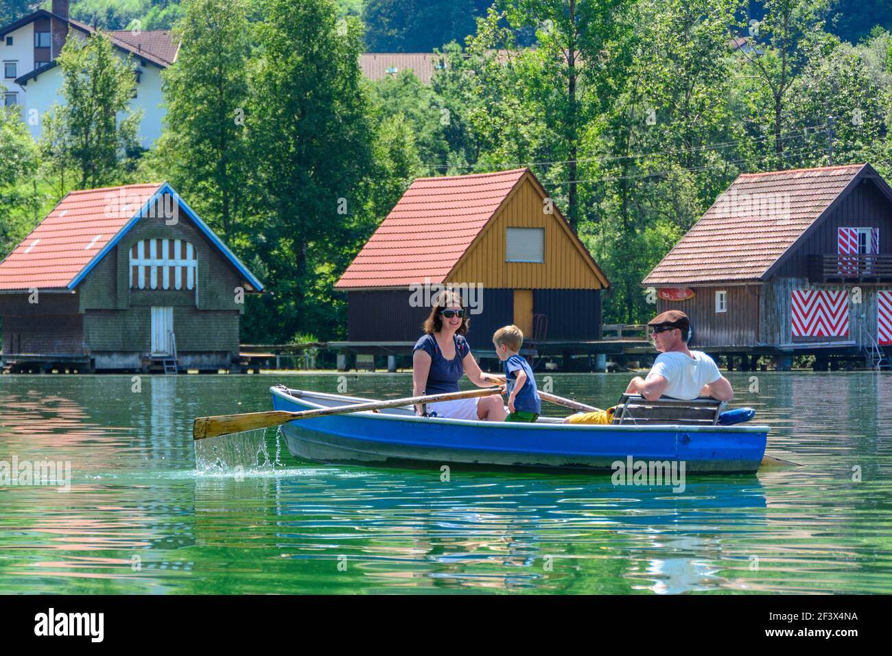 Family tour with rowboat on Alpsee Stock Photo - Alamy