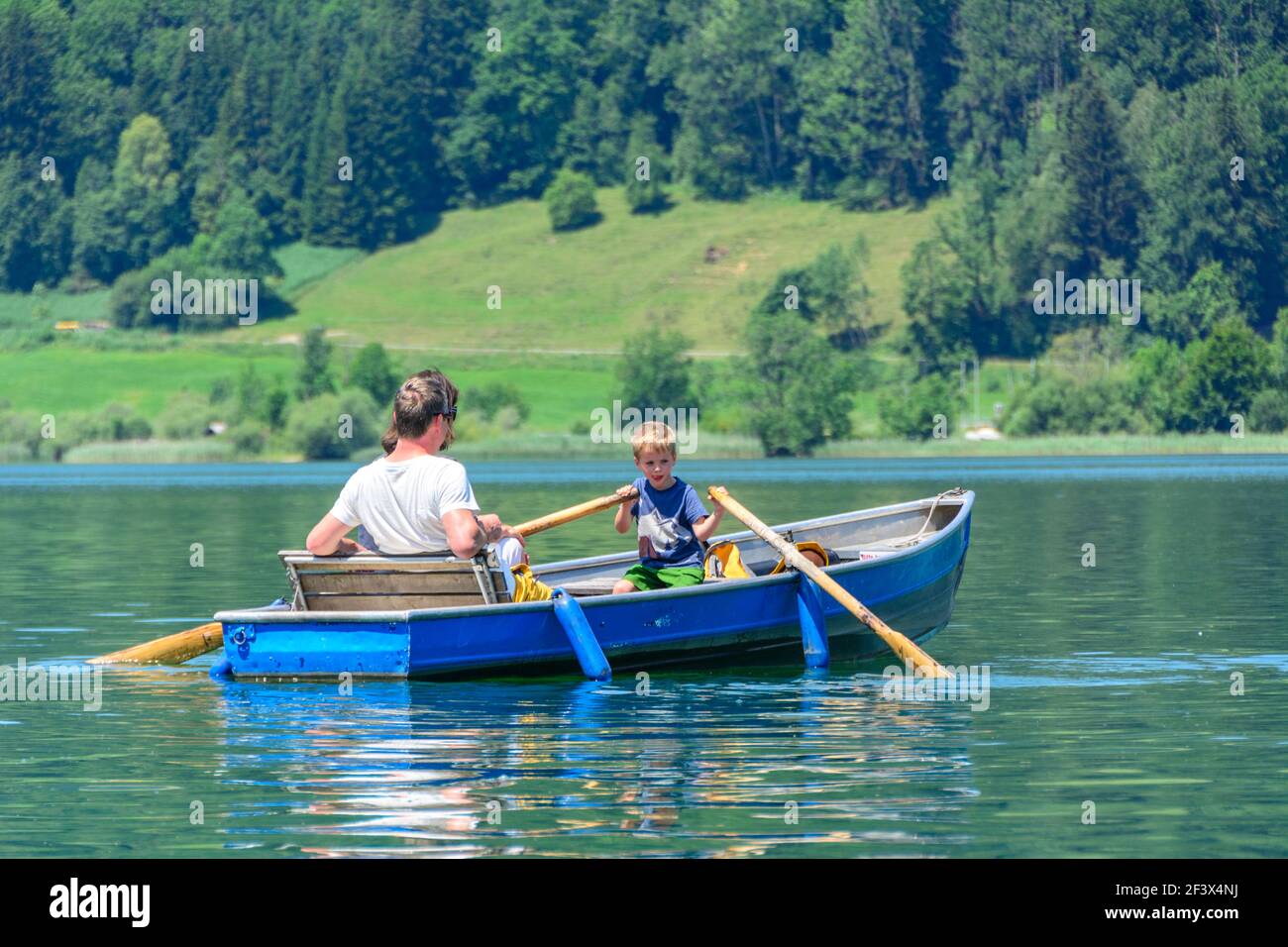 Family tour with rowboat on Alpsee Stock Photo - Alamy