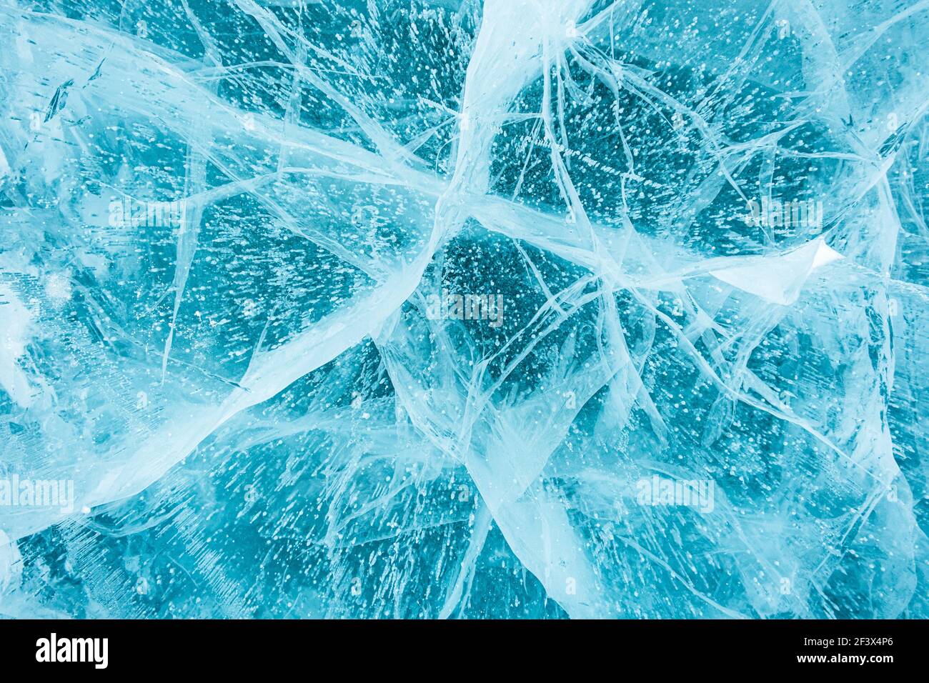 Texture of beautiful blue ice with cracks and air bubbles in the frozen ...