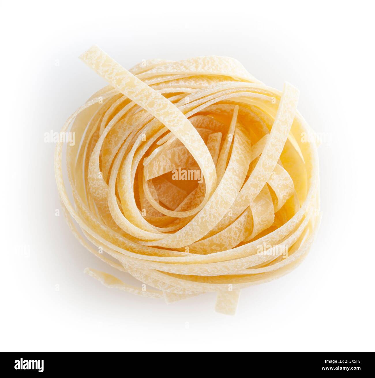 Uncooked tagliatelle pasta isolated on white background with clipping ...