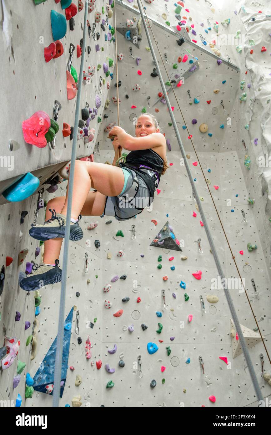 Female climber during her strenuous workout at a wall in indoor ...