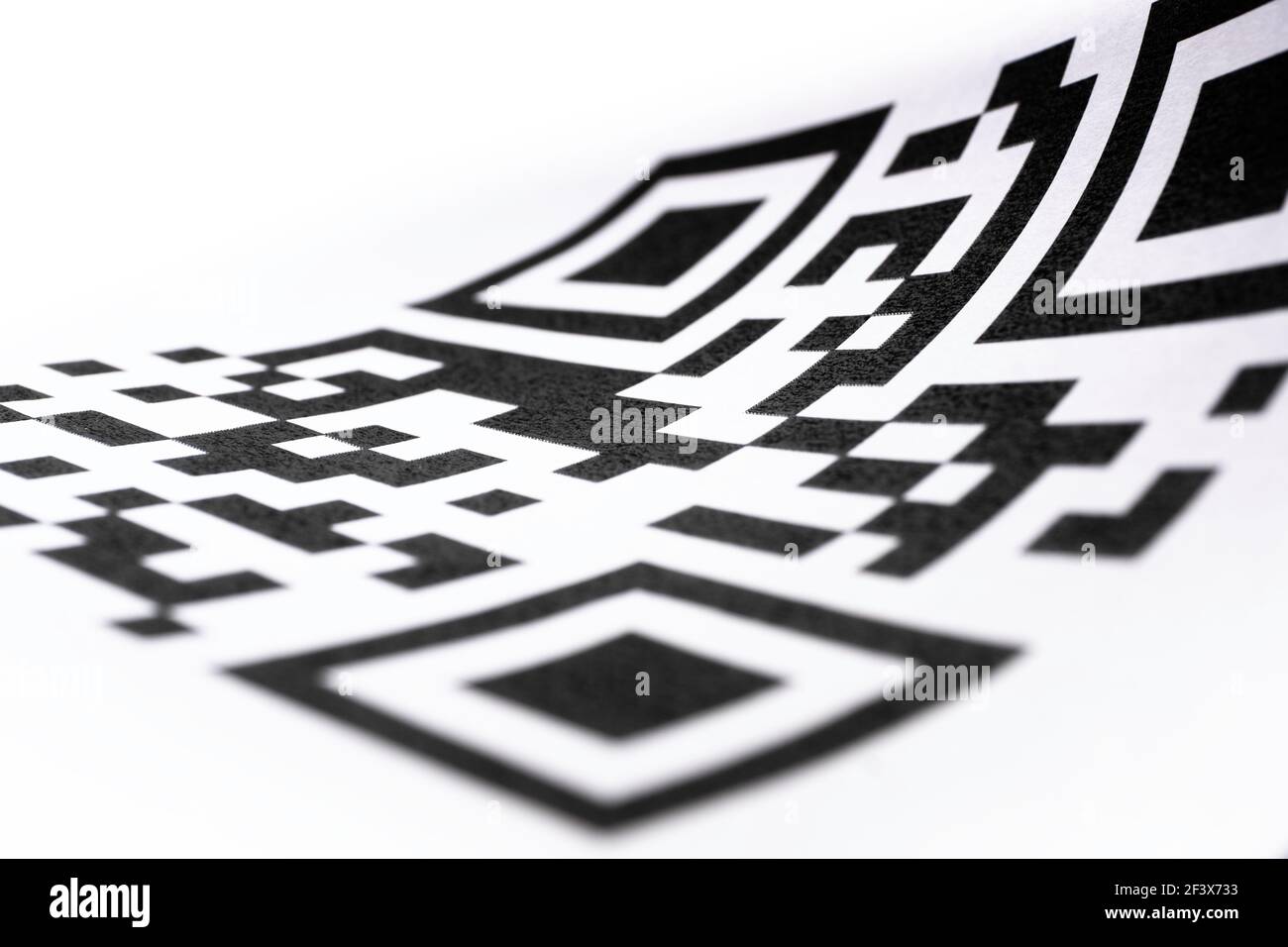 QR code on curled paper. Focus on the center of the code, shallow depth ...