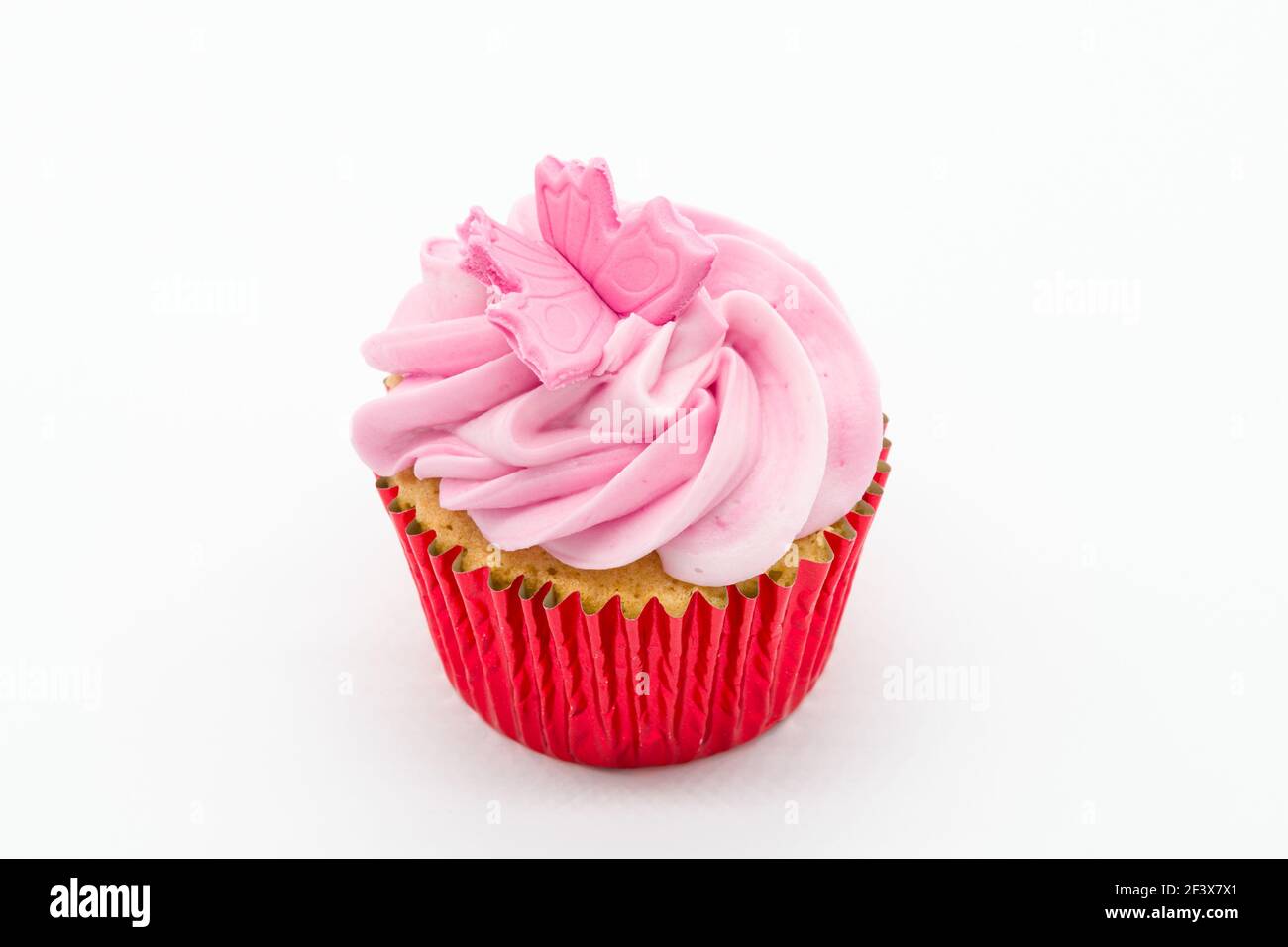 Easter cup cake with pink icing and red sponge casings on a white ...