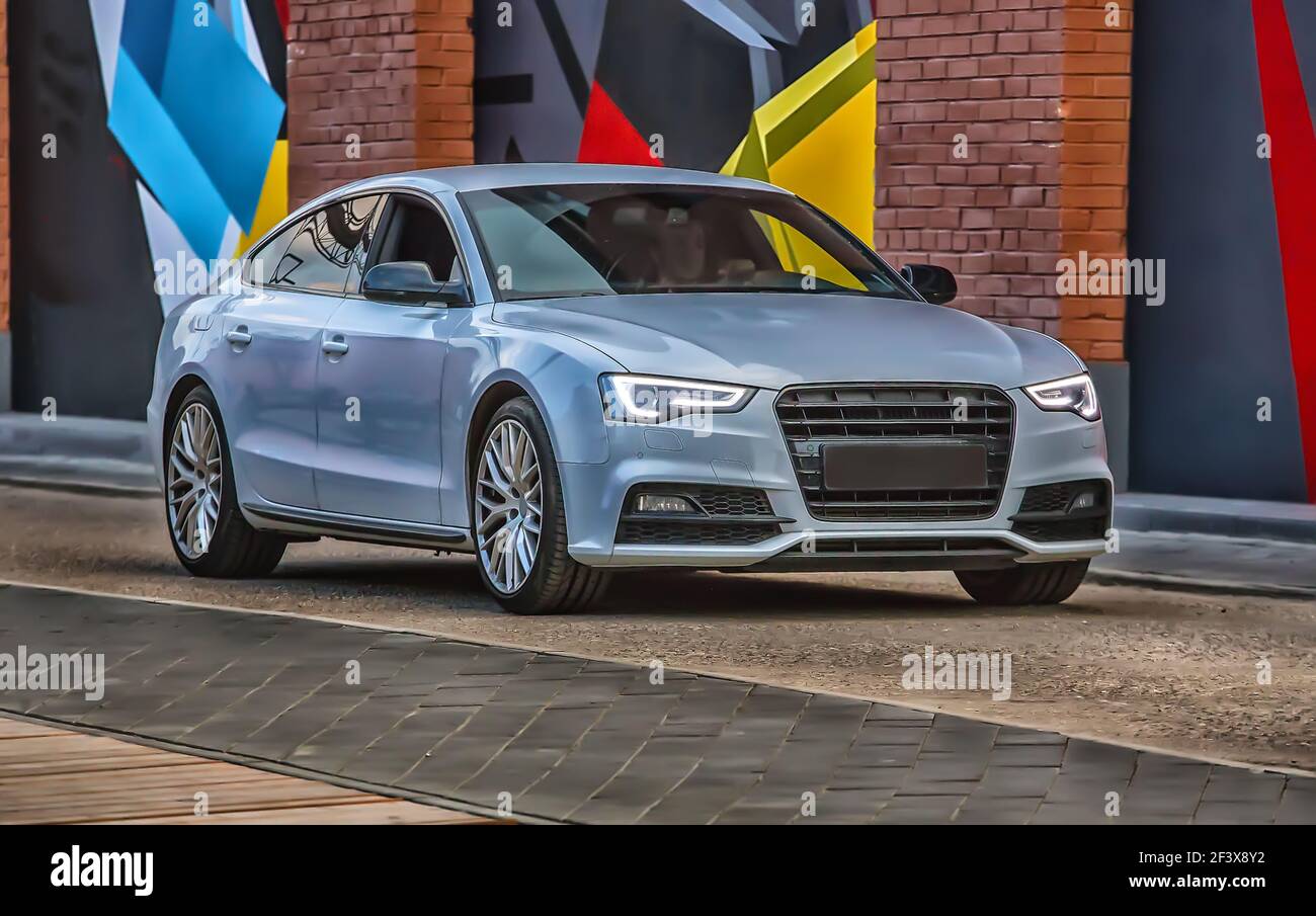 modern luxury car moves on the street in the city in the evening Stock ...